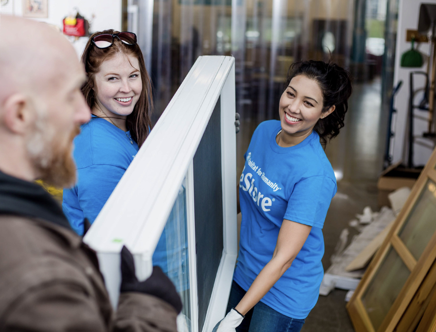volunteers carrying window - Habitat for Humanity of Fond du Lac County